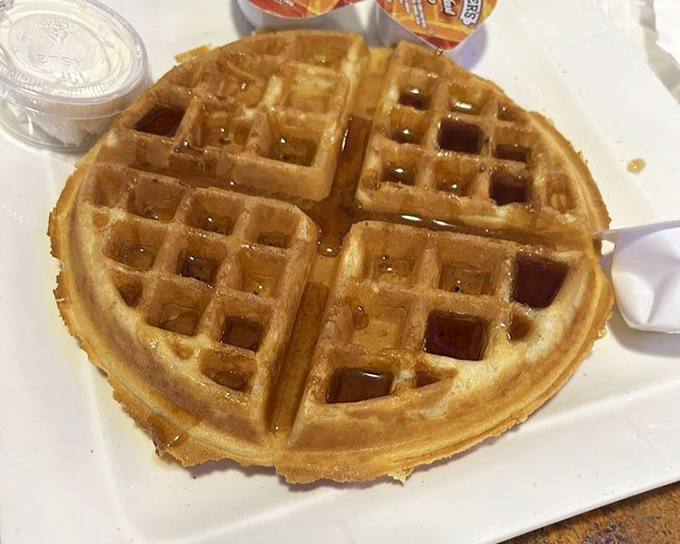 The classic waffle: perfectly golden squares creating pockets for maple syrup to pool like tiny lakes of sweetness.