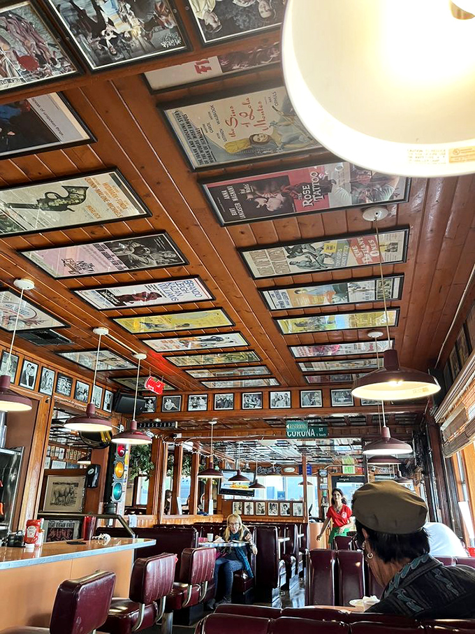 The ceiling's vintage movie poster collection offers entertainment overhead—like Netflix for your neck while waiting for your pancakes.
