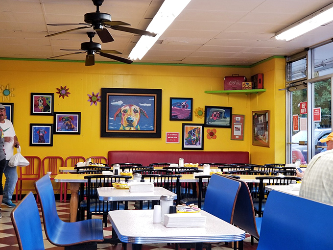 Colorful local art adorns sunny yellow walls, creating the perfect backdrop for morning conversations and coffee refills.
