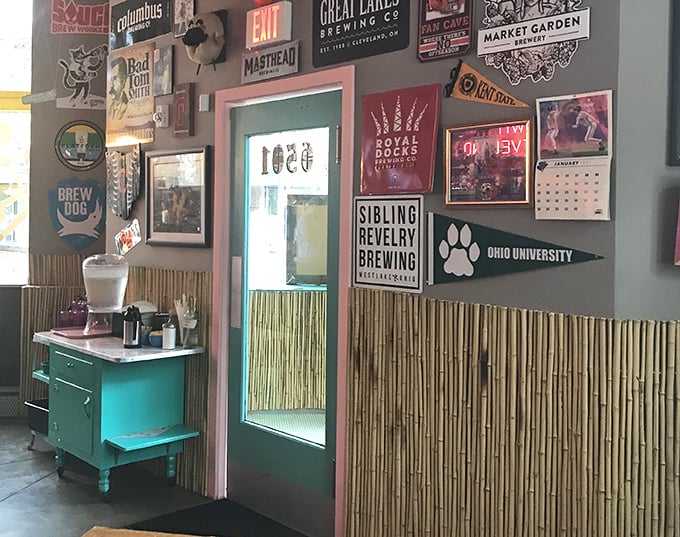 A gallery wall of beer memorabilia pays homage to Ohio's craft brewing heritage, framed by bamboo accents that somehow make perfect sense.