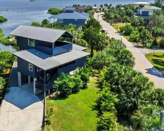 Elevated homes with generous porches embrace the coastal lifestyle, designed for catching breezes and watching osprey soar over the water.