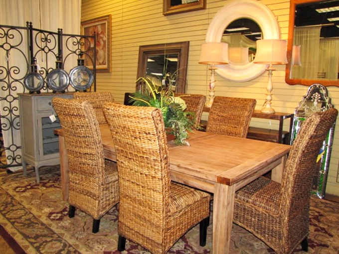 Wicker dining chairs bring a touch of coastal Florida living to this rustic wooden table—casual elegance at its finest.