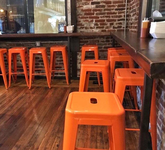 Those bright orange stools aren't just a pop of color&mdash;they're your front-row seats to the best chicken show in Philadelphia.