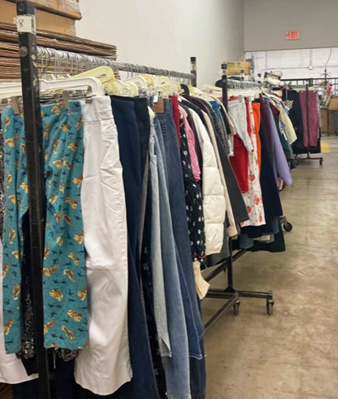 The clothing racks: a textile rainbow where fashion trends from every decade hang in peaceful coexistence.