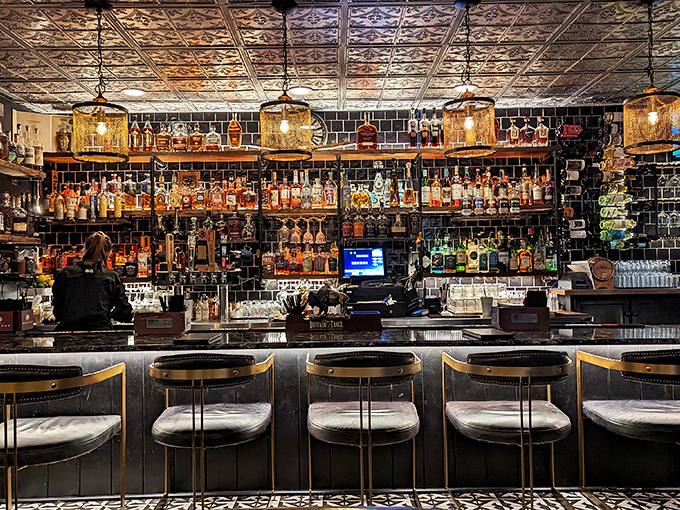 The bar at Beckett's doesn't just serve drinks&mdash;it showcases them like liquid art against that dramatic black tile backdrop.
