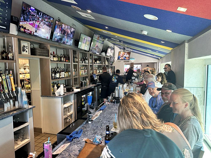 The bar buzzes with that perfect blend of locals and visitors, all united in pursuit of good drinks and the inside scoop on where to catch tomorrow's dinner.