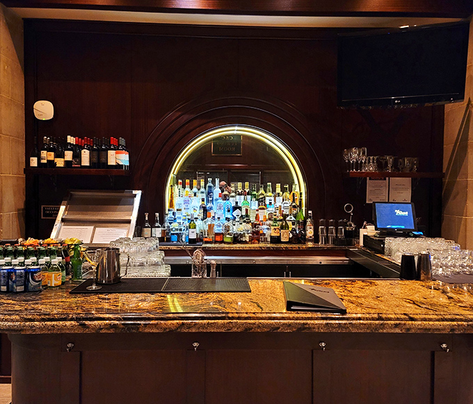 The bar's curved archway frames bottles like artwork in a museum. Where financial transactions once happened, now it's liquid investments of a different kind.