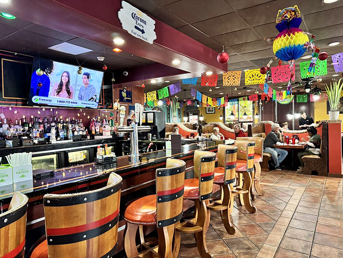 The bar where margarita dreams come true, with barrel stools that say "stay awhile" and colorful banners that say "celebrate everything."