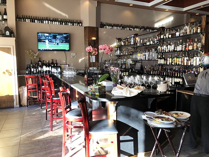 The bar gleams with bottles like a library of liquid possibilities, each promising to enhance your prime rib experience in its own special way.