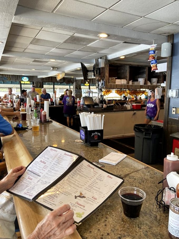 The bar area: where locals exchange fishing tales that grow taller with each round, and newcomers quickly feel like regulars.
