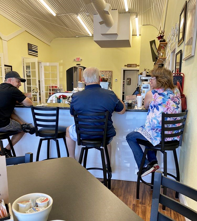The counter seating area where breakfast dreams come true. Notice the sign that says "Please wait to be seated" &ndash; words worth heeding for biscuit and gravy nirvana.