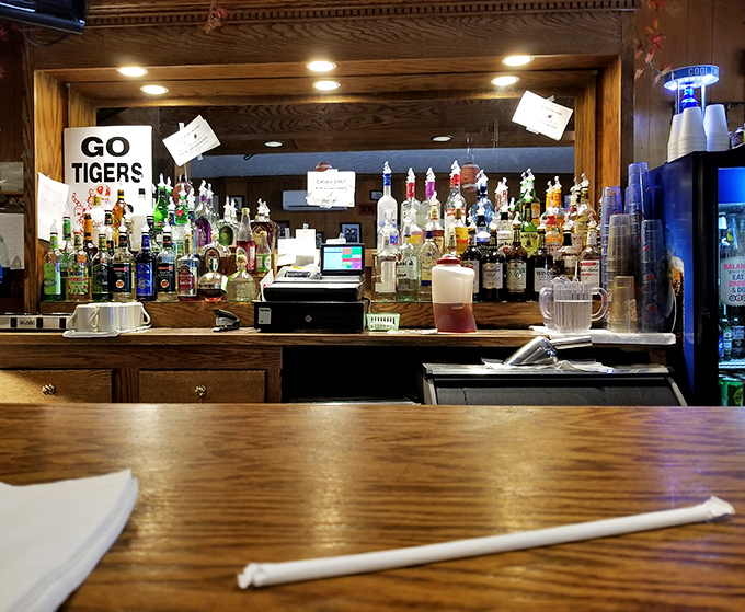 The bar area&mdash;where "Go Tigers" signs and liquor bottles create the perfect backdrop for solving world problems.