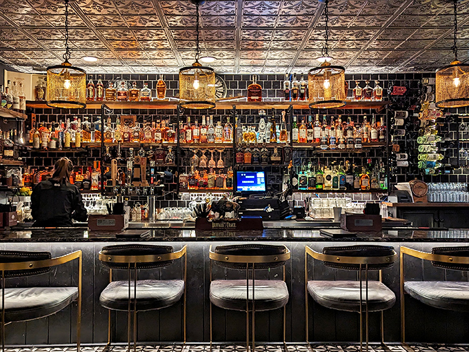 A bar display that would make a spirits enthusiast weak in the knees. Liquid treasures lined up like soldiers ready for duty.