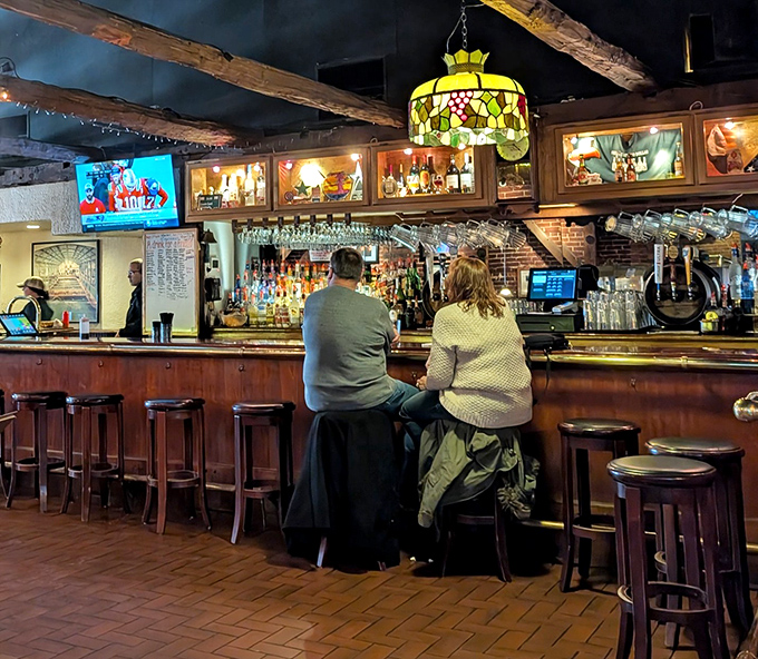 Comfortable bar seating with cushioned stools where regulars gather to debate sports and share wing wisdom.