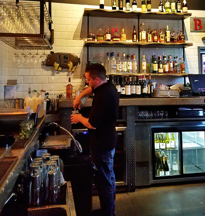 Behind the bar, the choreography of cocktail creation unfolds, where each pour and shake is performed with practiced precision.