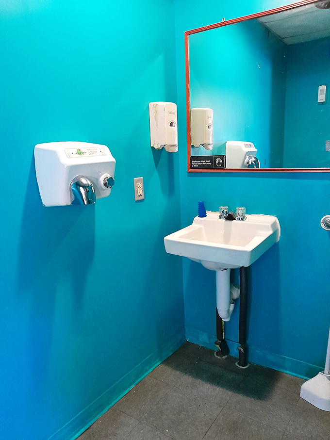 Even the bathroom stays committed to the theme. It's like washing your hands inside a swimming pool, minus the chlorine and suspicious warm spots.