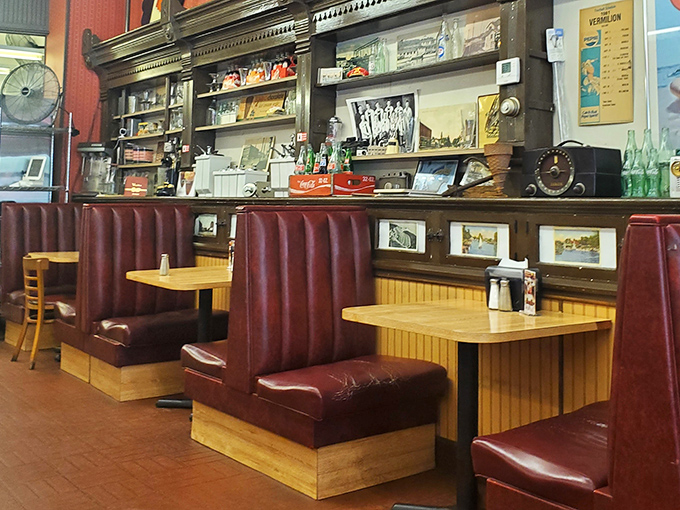 These burgundy booths could tell stories that would make a novelist jealous. Wood paneling and nostalgia&mdash;the perfect pairing. 