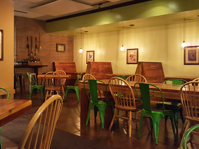 The mix of wooden Windsor chairs and bright green metal seating somehow works perfectly, like peas and pasta or Dean Martin and Jerry Lewis.