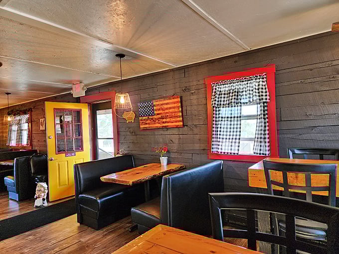 Rustic wooden booths against dark walls with pops of red and yellow create the perfect backdrop for the serious business of BBQ consumption.
