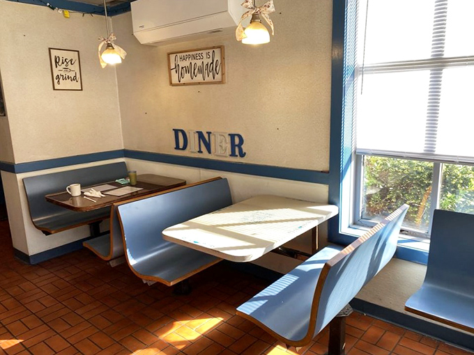 Classic blue booths bathed in morning light &ndash; each one a private breakfast sanctuary for coffee contemplation.