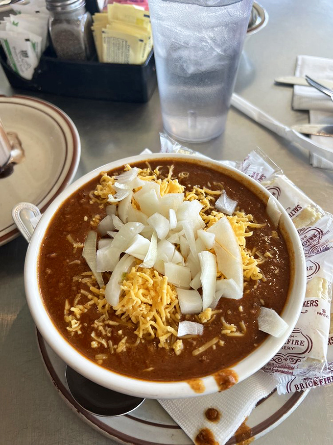 A bowl of chili topped with the holy trinity—cheese, onions, and more cheese. Winter in Denver just met its match.
