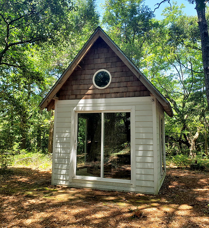 This storybook cabin nestled among the trees looks like it's waiting for Goldilocks. Sunlight dapples through leaves, creating nature's stained glass.