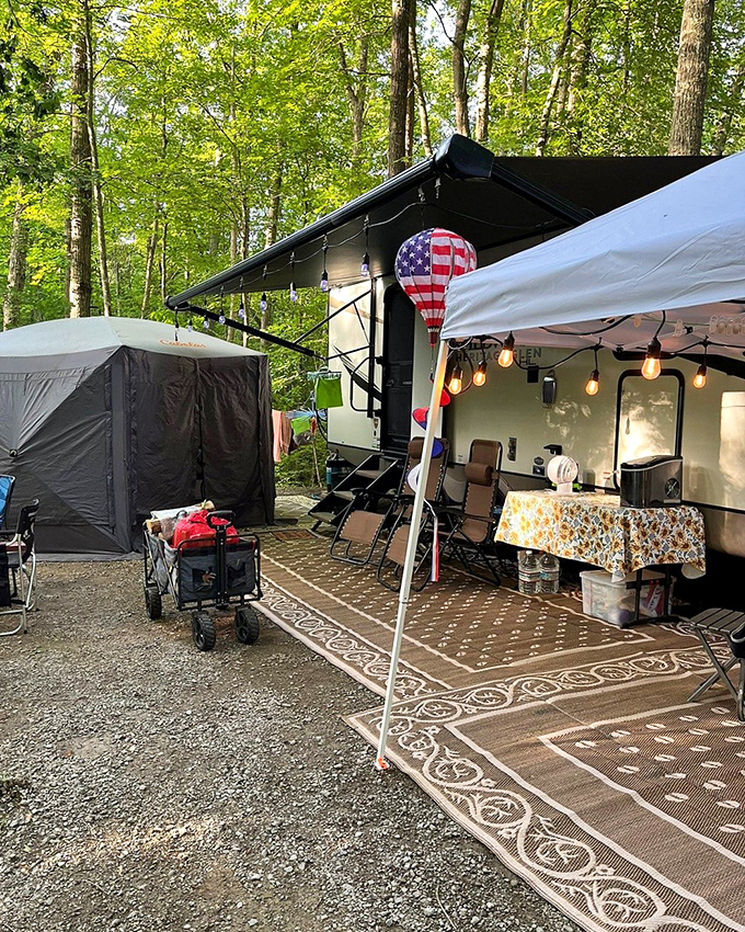 Camping at Breaks: where string lights and American flags transform a patch of forest into the coziest outdoor living room imaginable.