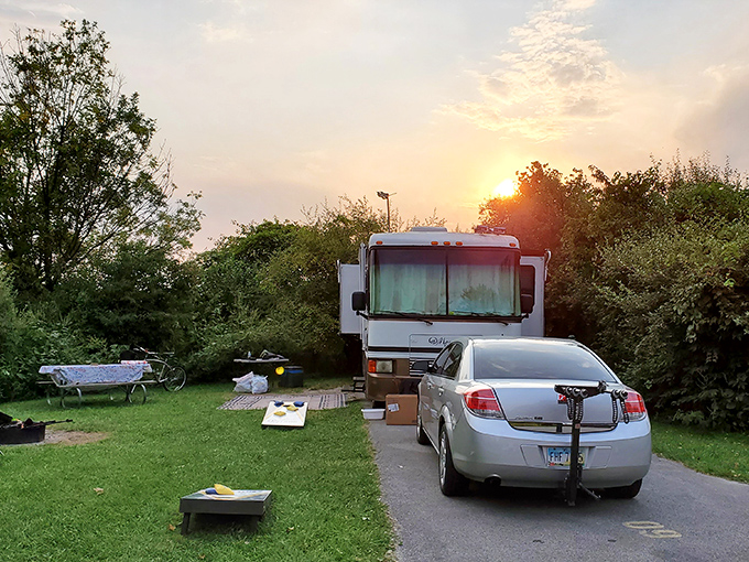 Sunset camping at its finest – an RV nestled among greenery creates the perfect basecamp for park adventures.