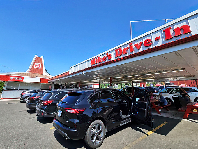 Modern cars line up where generations have parked before them, drawn by the timeless appeal of a perfect drive-in meal.