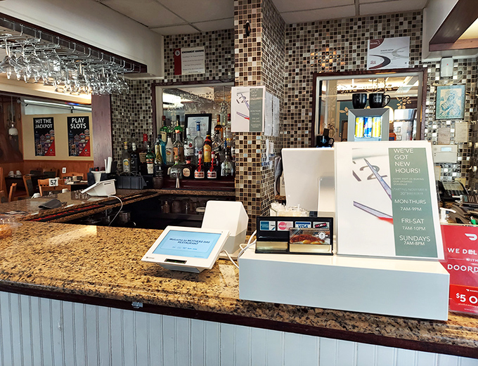 The bar area doubles as checkout, with mosaic tile backsplash adding unexpected elegance. Where breakfast dreams begin and satisfied customers settle up.