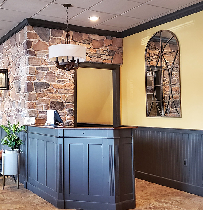 The host station blends rustic stone with modern touches. First impressions matter, and this welcoming entrance sets the tone for the comfort awaiting beyond.