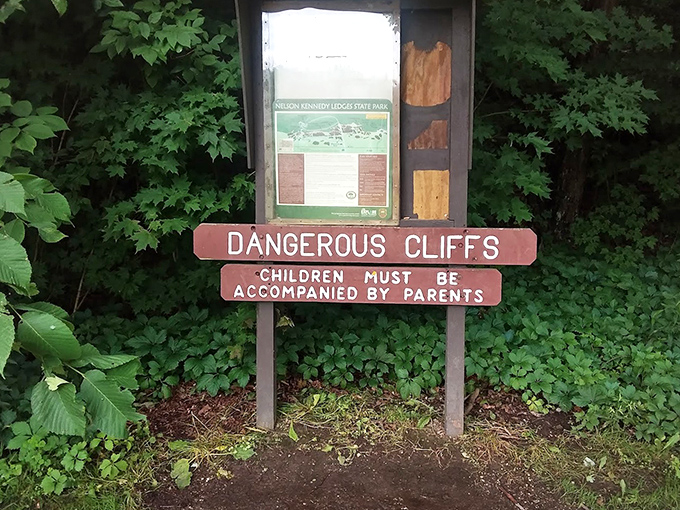 The sign says "Dangerous Cliffs" but really means "Instagram at your own risk." Nature's beauty comes with fine print worth reading.