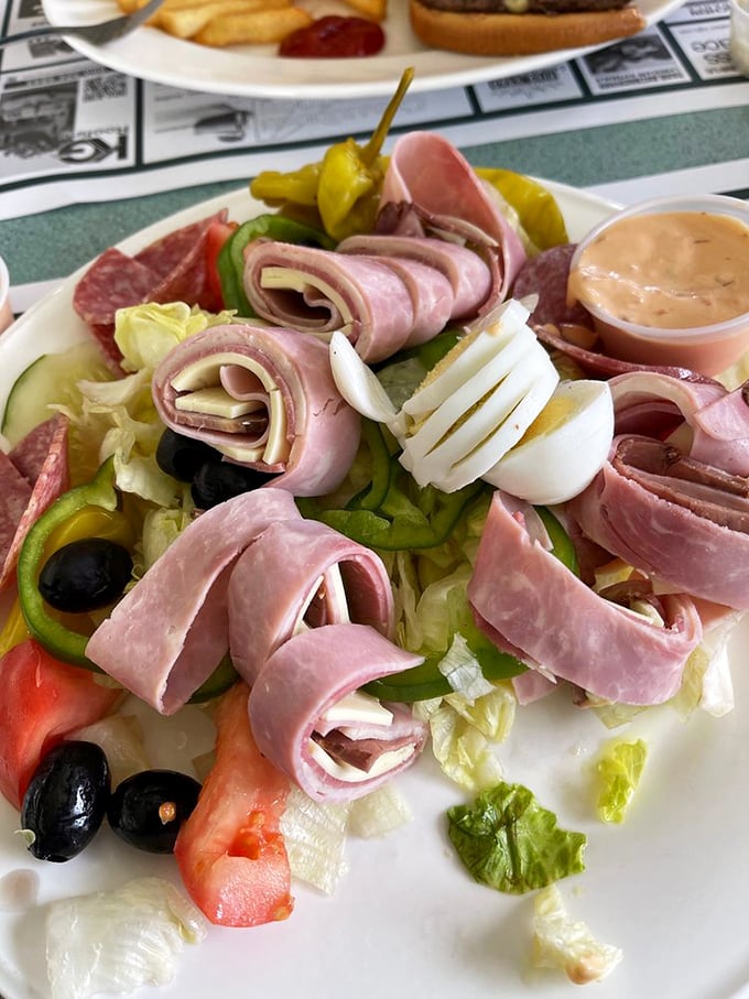A chef's salad that doesn't apologize for being generous. Those rolled deli meats are doing synchronized swimming in a pool of fresh vegetables.