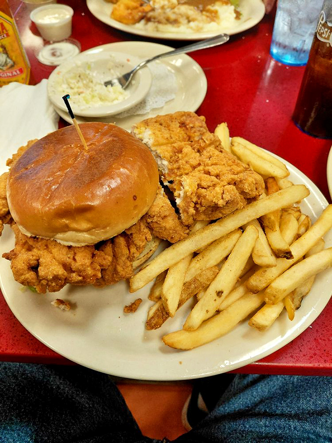 A chicken sandwich that's audaciously oversized, perfectly golden, and served with fries that clearly never saw the inside of a freezer.