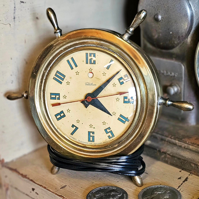 A nautical timepiece that brings maritime charm to any desk. This captain's wheel clock sailed through decades to find its way here.
