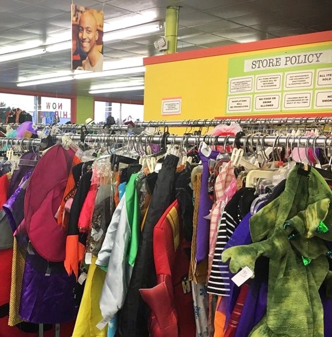 A rainbow of possibilities hanging on metal racks. Each garment carries whispers of its previous life while awaiting its next chapter.