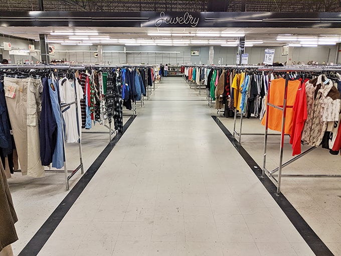 Color-coordinated racks stretch toward the horizon like a rainbow made entirely of secondhand fashion possibilities.