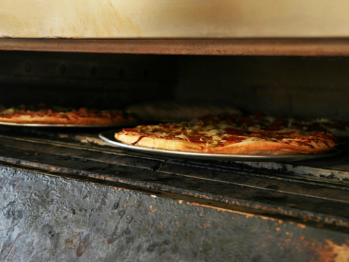 Where the magic happens – that ancient oven has seen more pizza transformations than most of us have had hot dinners.