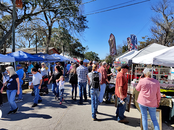 Festival crowds browse local wares under oak canopies, proving small towns still know how to throw the best parties.