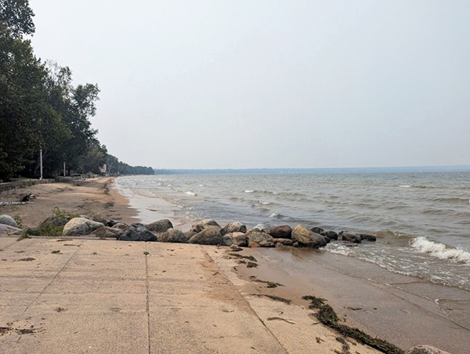 Concrete meets nature at Brimley's edge &ndash; human engineering and Superior's power finding respectful coexistence.