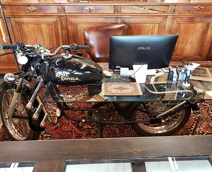 Who wouldn't want to answer emails at a desk with a Royal Enfield motorcycle as your coworker? Office design that would make Hemingway proud.