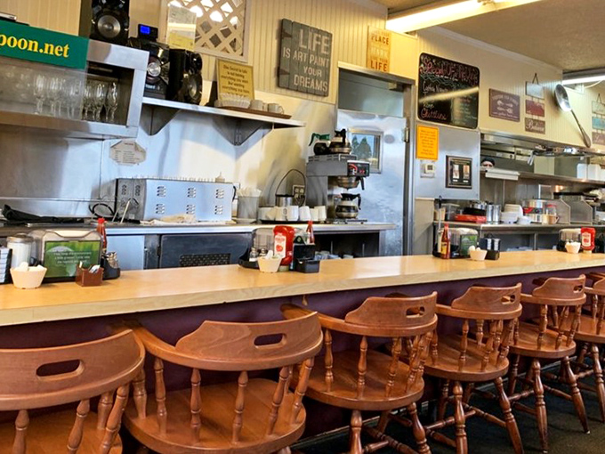 The counter seating offers a front-row view to breakfast theater. Those wooden captain's chairs have witnessed countless food epiphanies.