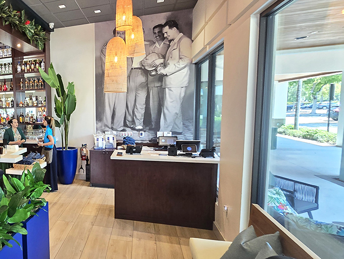 The host station features a striking black and white mural—a nod to Cuban heritage that grounds the modern space in tradition.