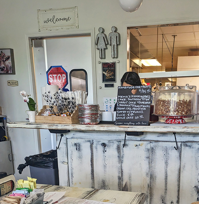 The counter area doubles as a dessert showcase. That "everything with love" sign isn't just cute decor&mdash;it's the restaurant's unofficial mission statement.