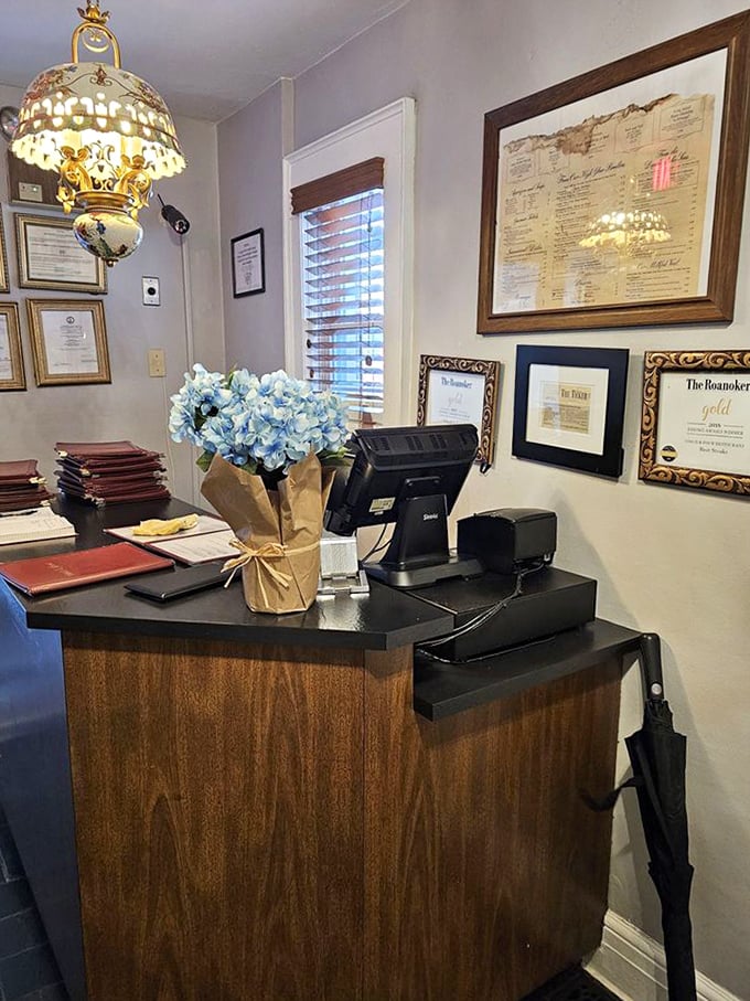 The host station, complete with awards and fresh flowers, silently communicates what you'll soon discover: this place takes hospitality as seriously as its prime rib.