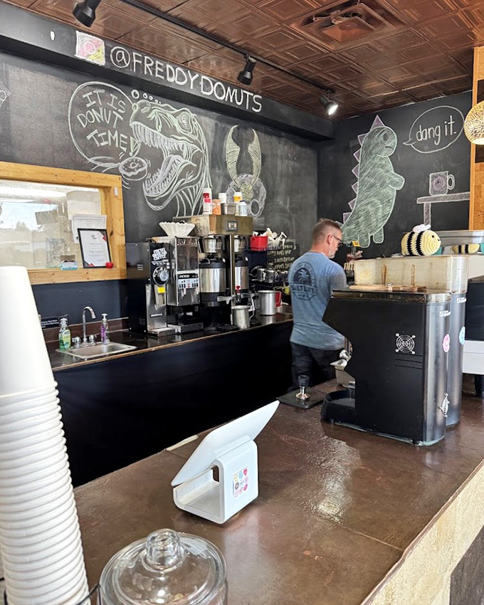 The coffee station, where liquid energy meets sugary delight. Chalk dinosaurs and bears on the walls remind us not to take our donuts too seriously.