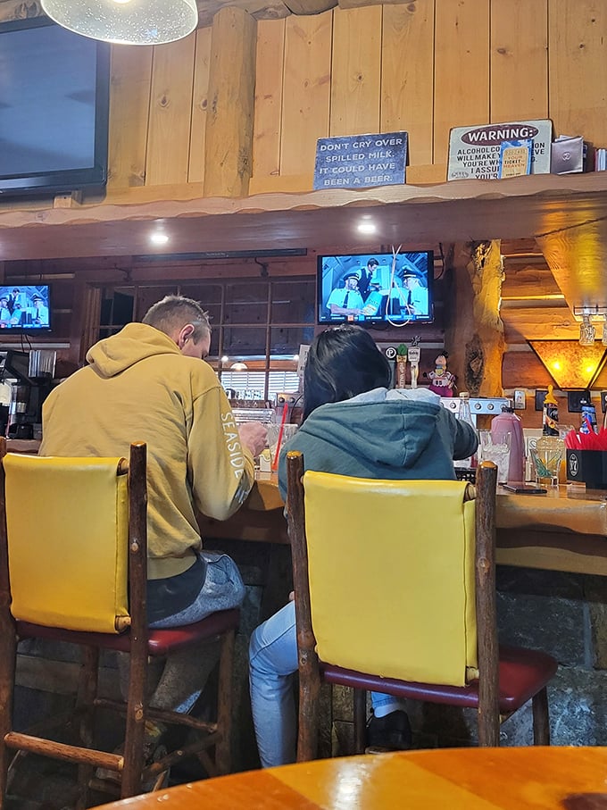 Counter seating where regulars solve world problems between bites, with that "Don't Cry Over Spilled Milk" wisdom overhead.