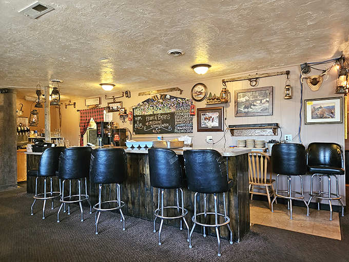 Counter seating where regulars perch, watching the kitchen ballet while trading stories beneath vintage lanterns and local artwork.