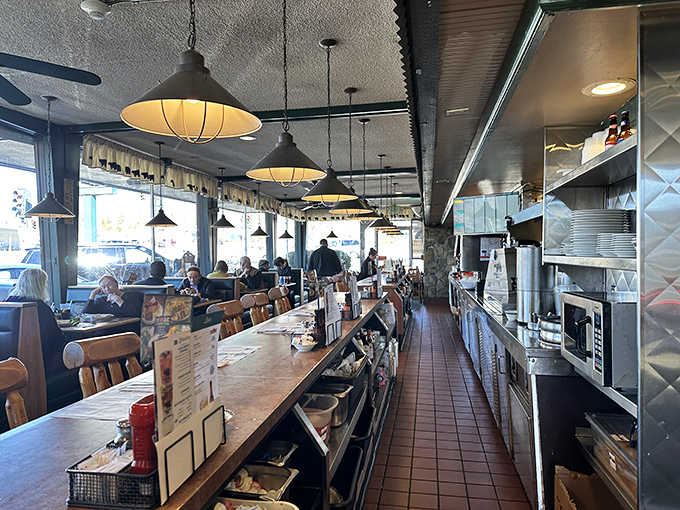 The counter seating offers front-row tickets to the culinary show, where servers hustle and cooks transform simple ingredients into comfort food magic.