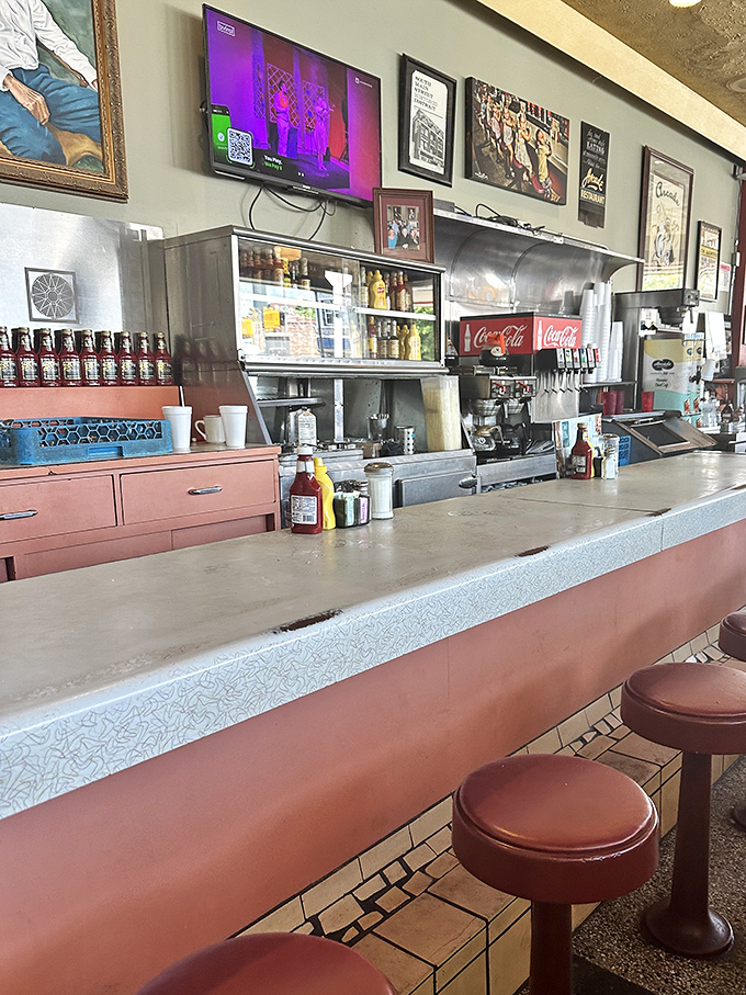 The counter tells stories of countless elbows, coffee cups, and conversations &ndash; a front-row seat to the short-order ballet that unfolds daily.